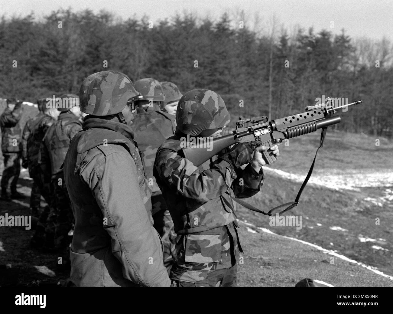A Navy ROTC midshipman fires an M-203 grenade launcher mounted on an M ...