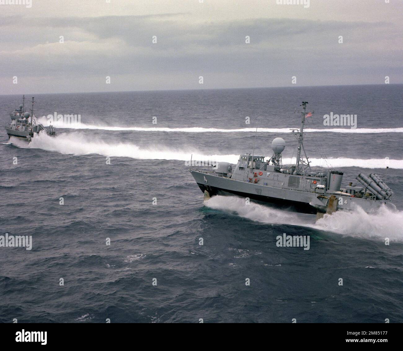 An port quarter view of the patrol combatant-missile (hydrofoils) USS Aquila (PHM-4), foreground ...