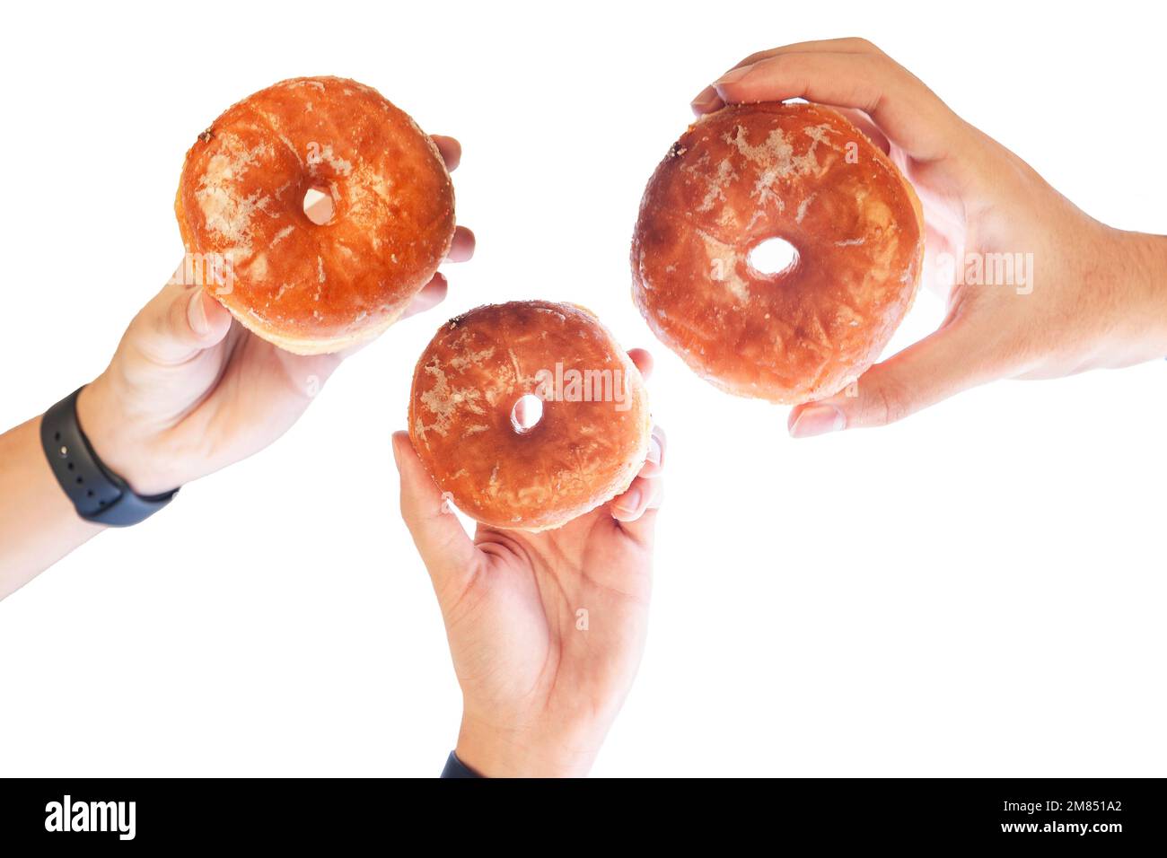 Different hands holding glazed doughnuts in different angles Stock ...