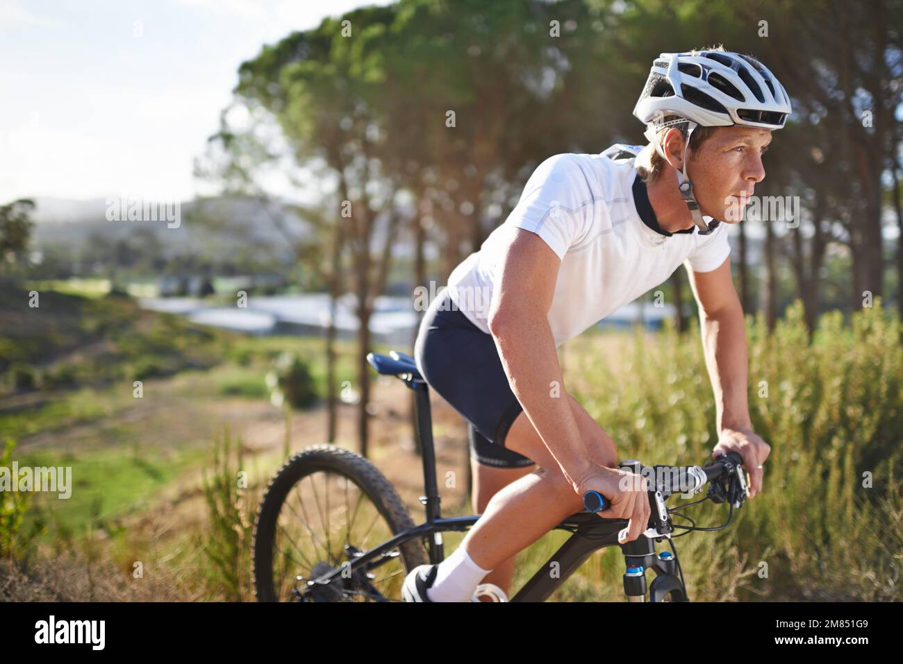Nothing beats an extreme bike ride. Fit cyclist riding across rough ...