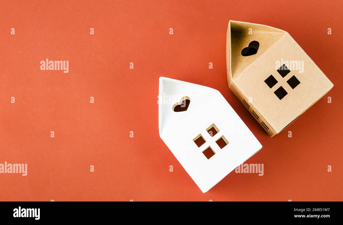 White and Brown paper house origami on red background with empty space ...