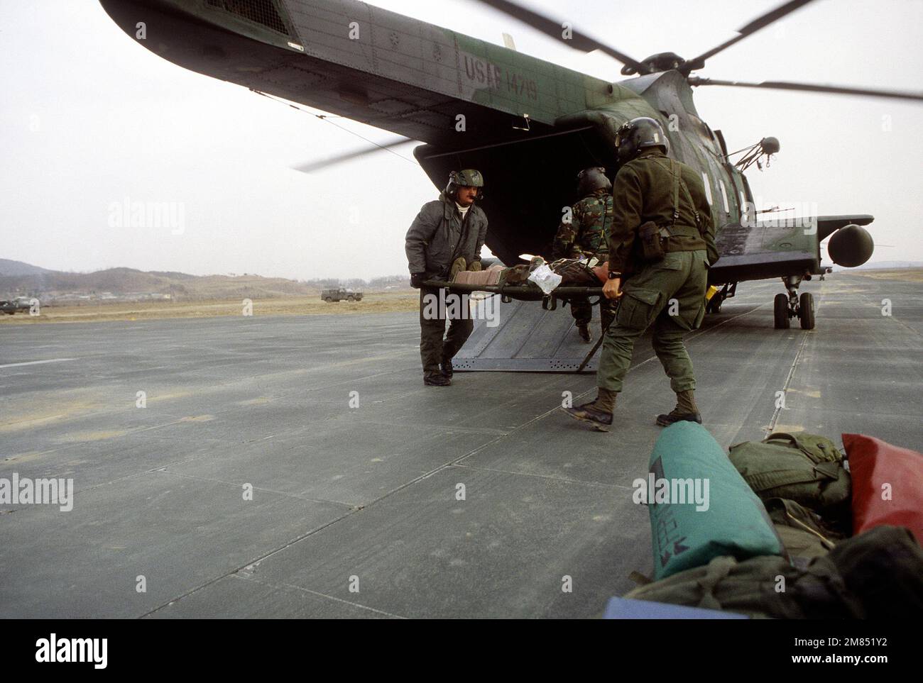 A "casualty" is carried into a 38th Aerospace Rescue and Recovery ...