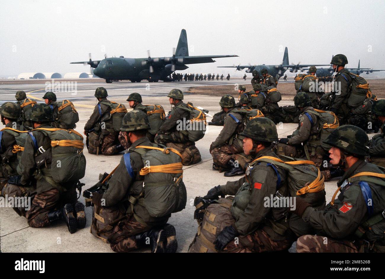 Korean paratroopers wait on the flight line before boarding C-130 ...
