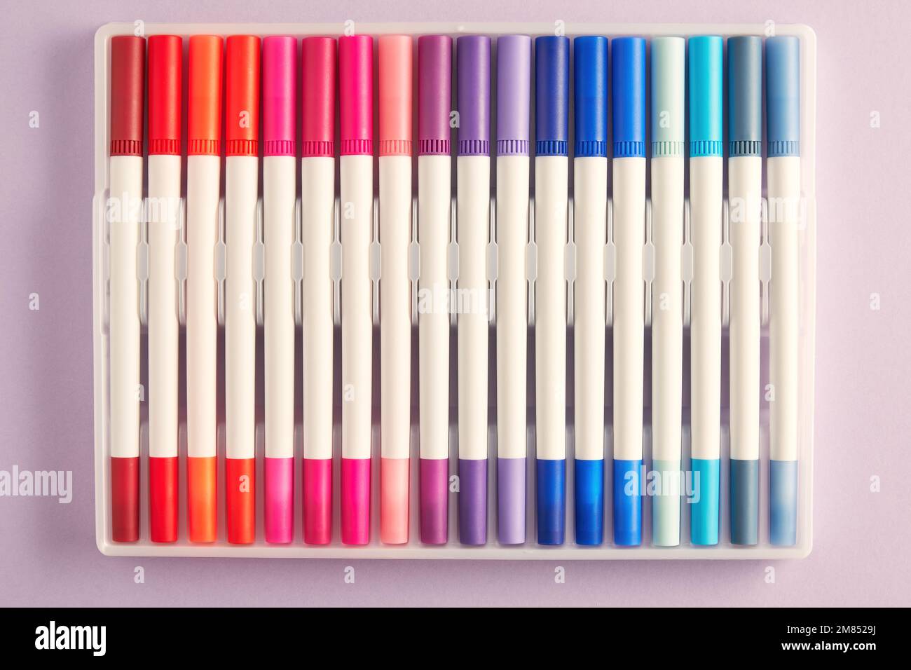 Collection of a watercolor markers for painting and sketching on purple ...