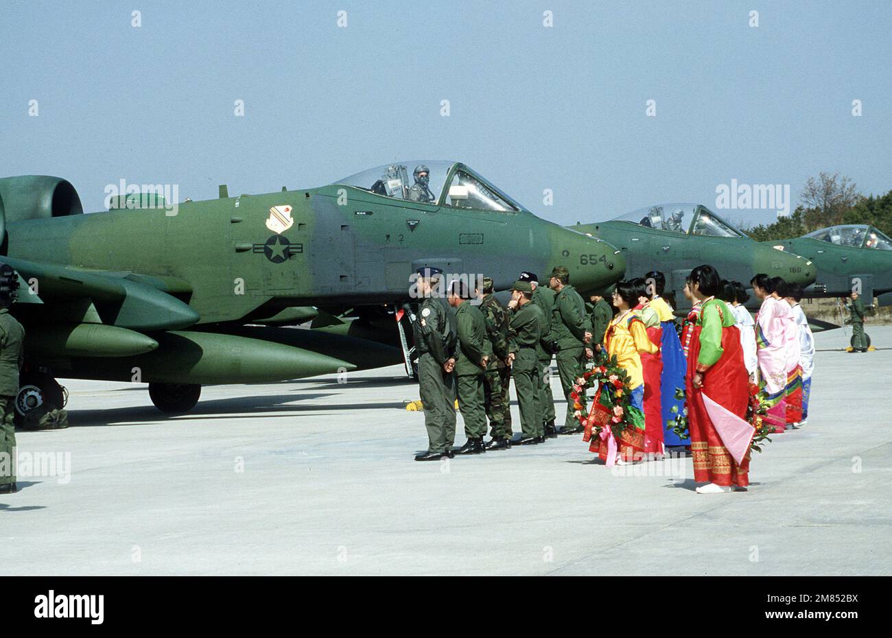 American ground support personnel and Korean welcoming committee ...