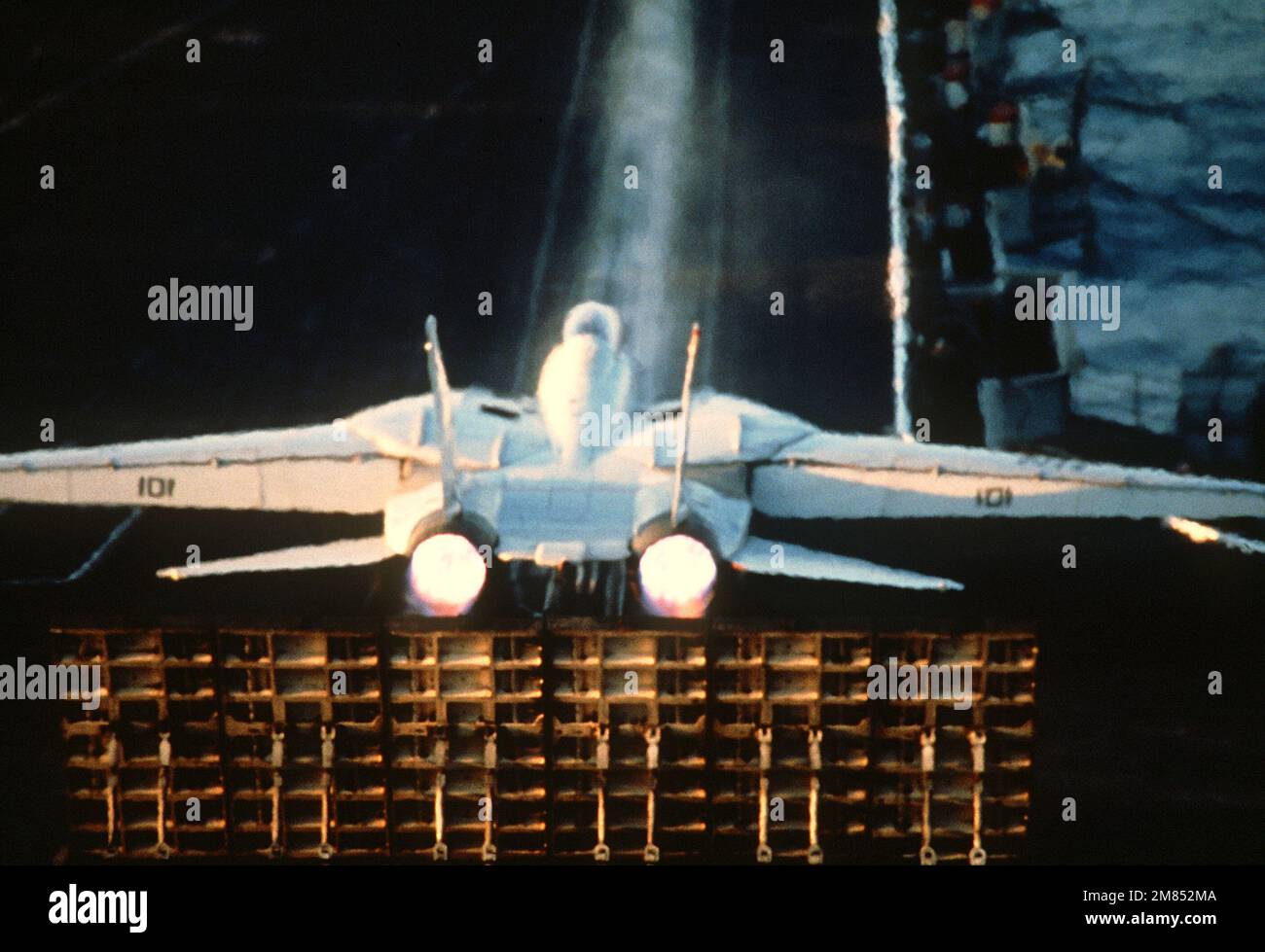 An F-14A Tomcat aircraft fires up its engines in front of a Mark 7 ...
