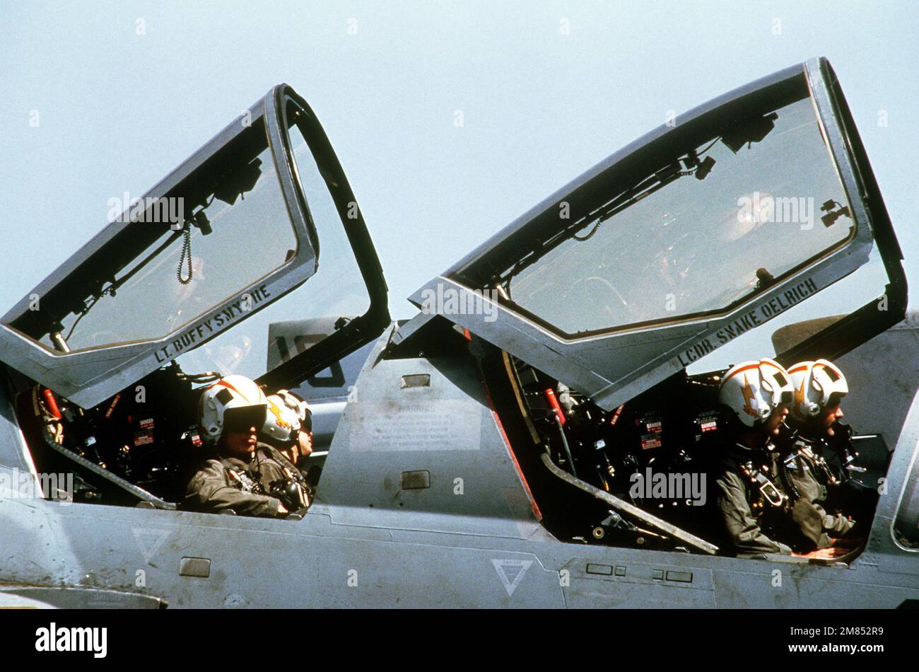 A flight crew sits in the cockpit of an EA-6B Prowler aircraft on the ...