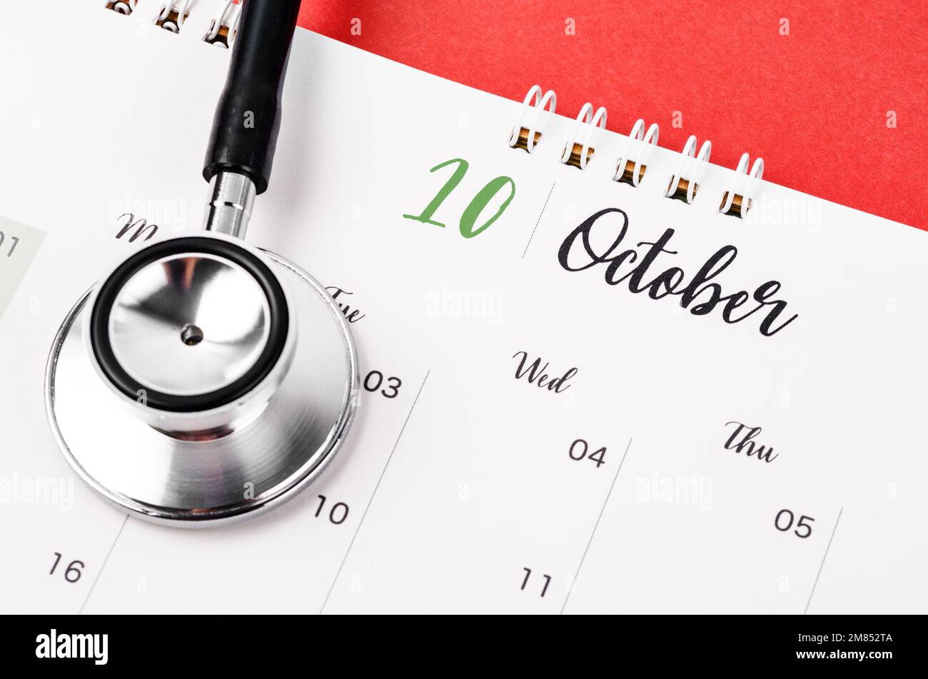 Stethoscope medical and October 2023 desk calendar on the red ...