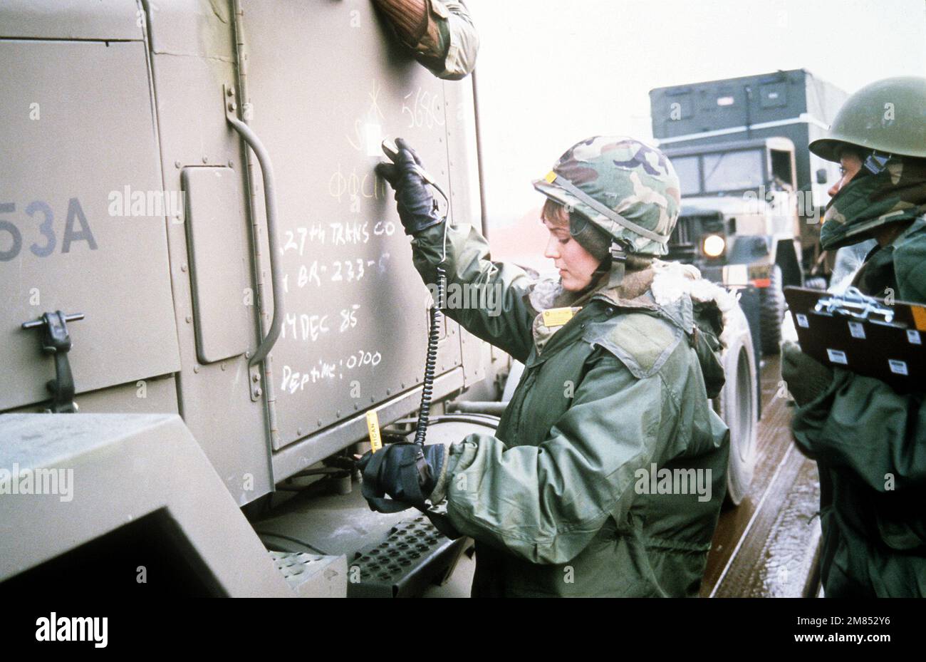 U.S. Army personnel use a laser scanner to read the bar code on the ...