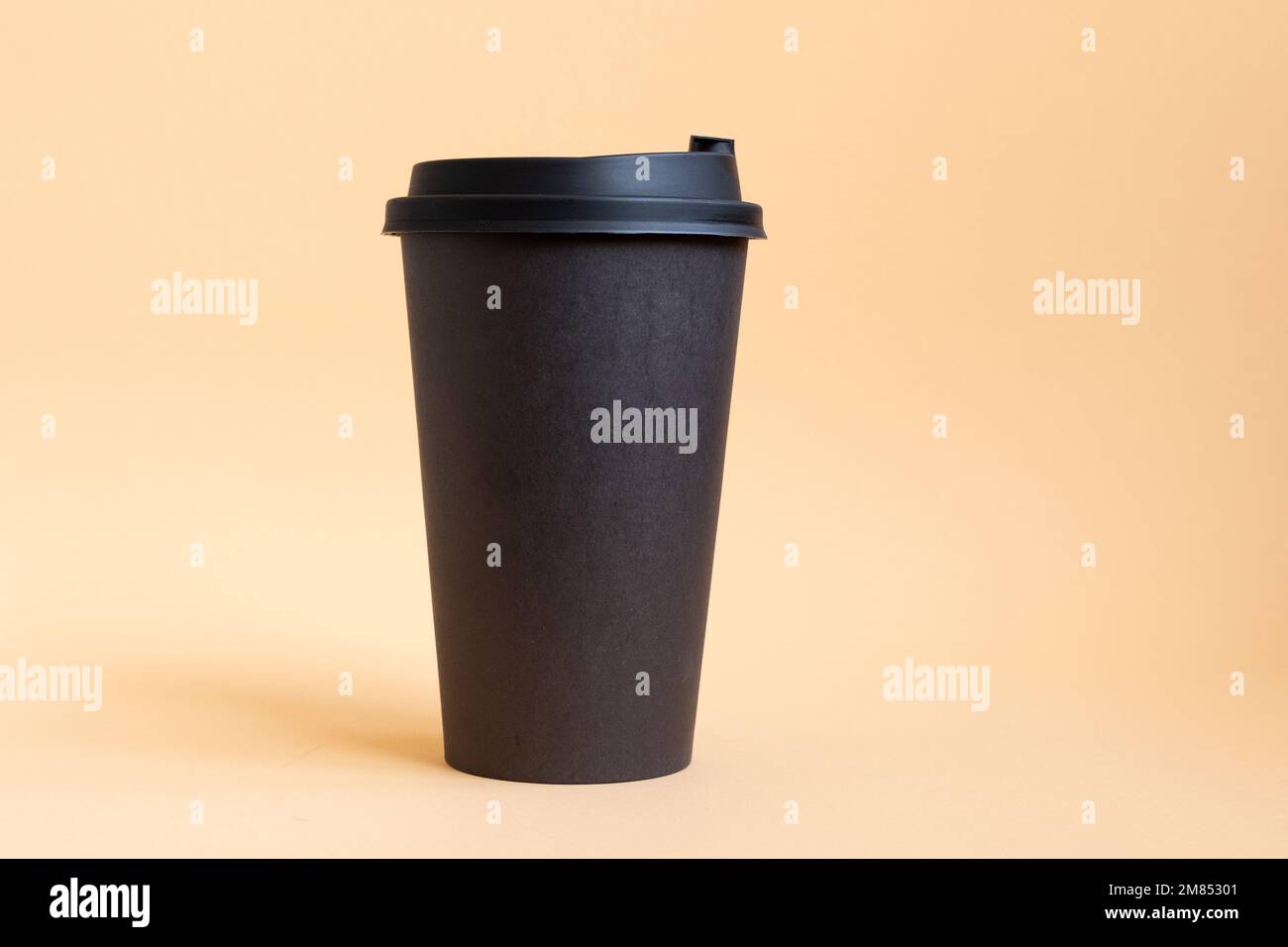 One takeaway black coffee cup on neutral background. Mock-up, nobody ...