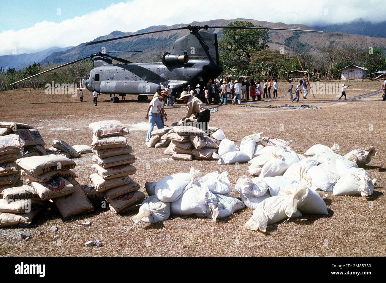 Food supplies are loaded aboard a CH-47 Chinook helicopter from the ...