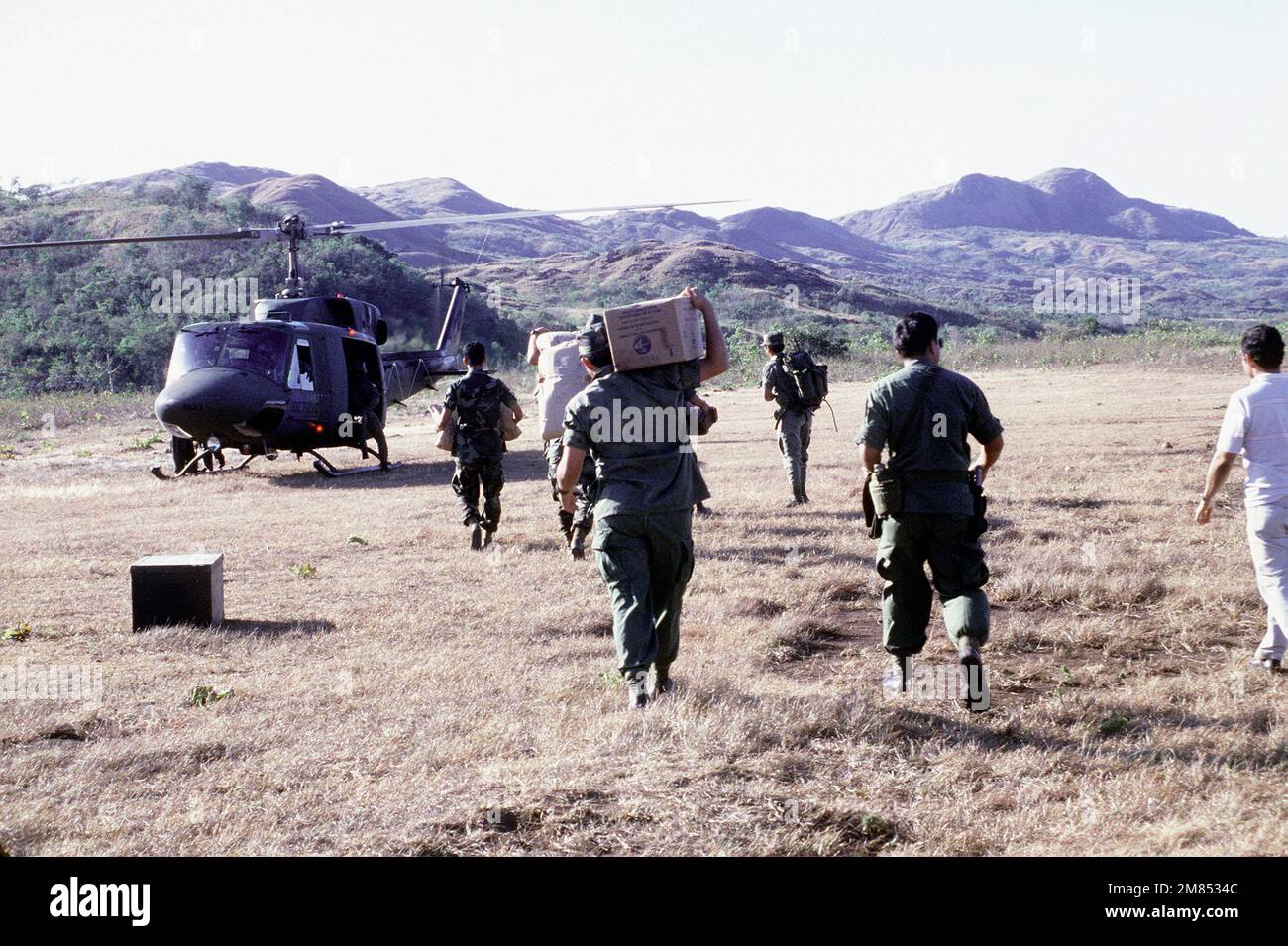 Supplies are loaded aboard a U.S. Air Force UH-1N Iroquois helicopter ...