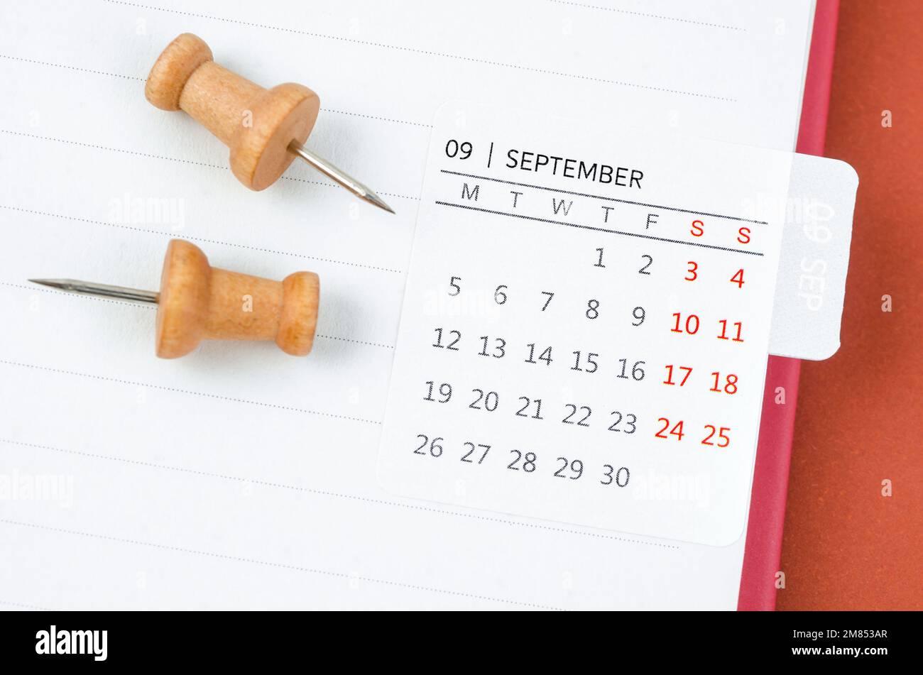 Mini September monthly calendar and wooden push pin on open diary Stock ...