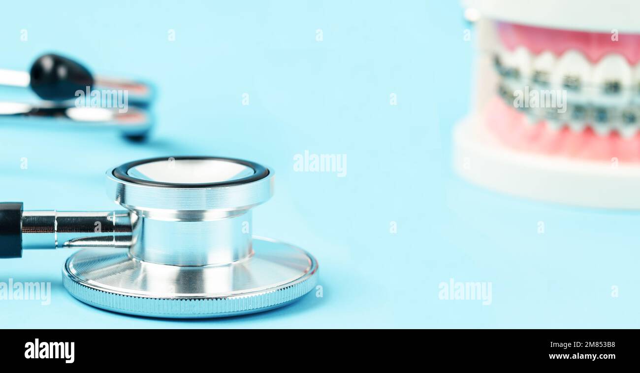 Medicine equipment stethoscope and metal wire dental braces on model ...