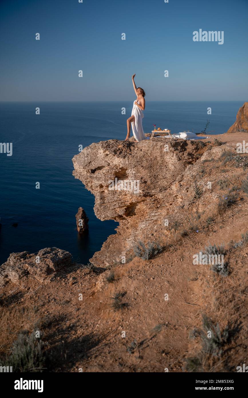 Woman wake up in bed wuth duvet and pillow over nature sea background ...
