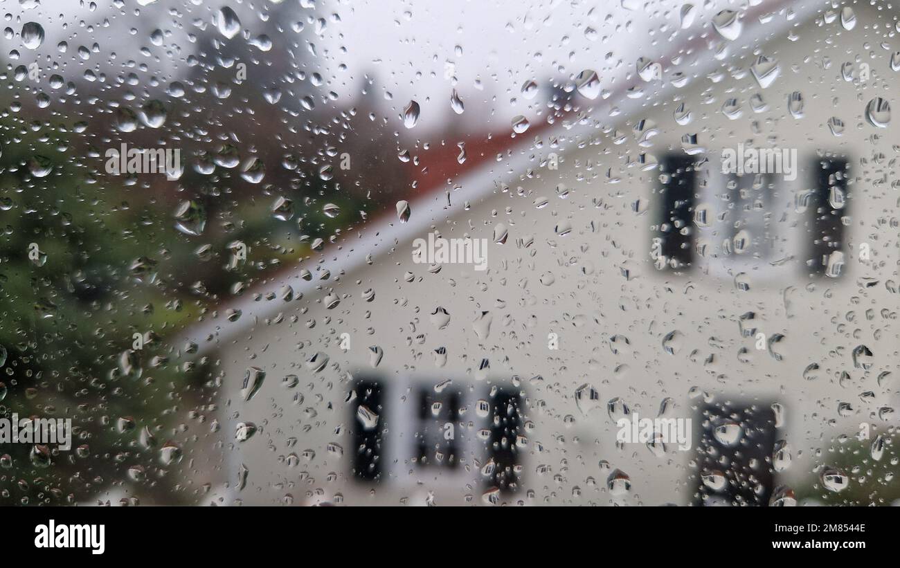Water rain drops on window with building Stock Photo - Alamy