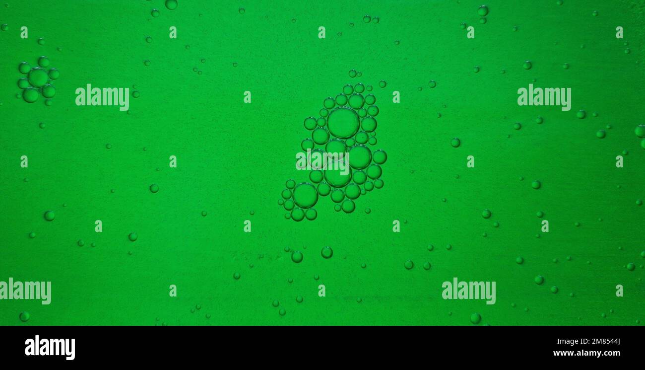 Oil bubbles on water green background Stock Photo - Alamy
