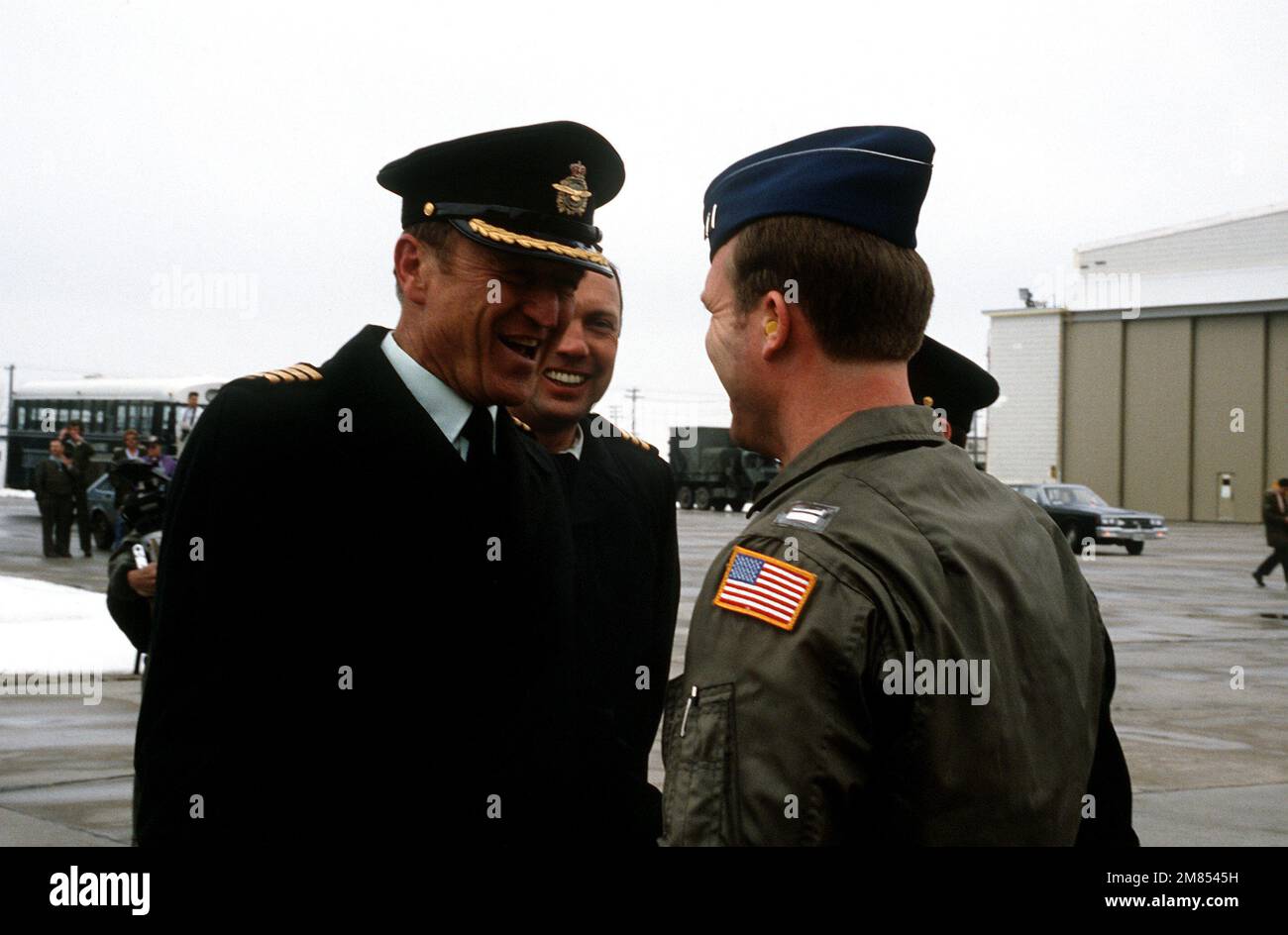 COL. Mike Zrymiak, base commander, greets CAPT. Peter A. Holzgang, a ...
