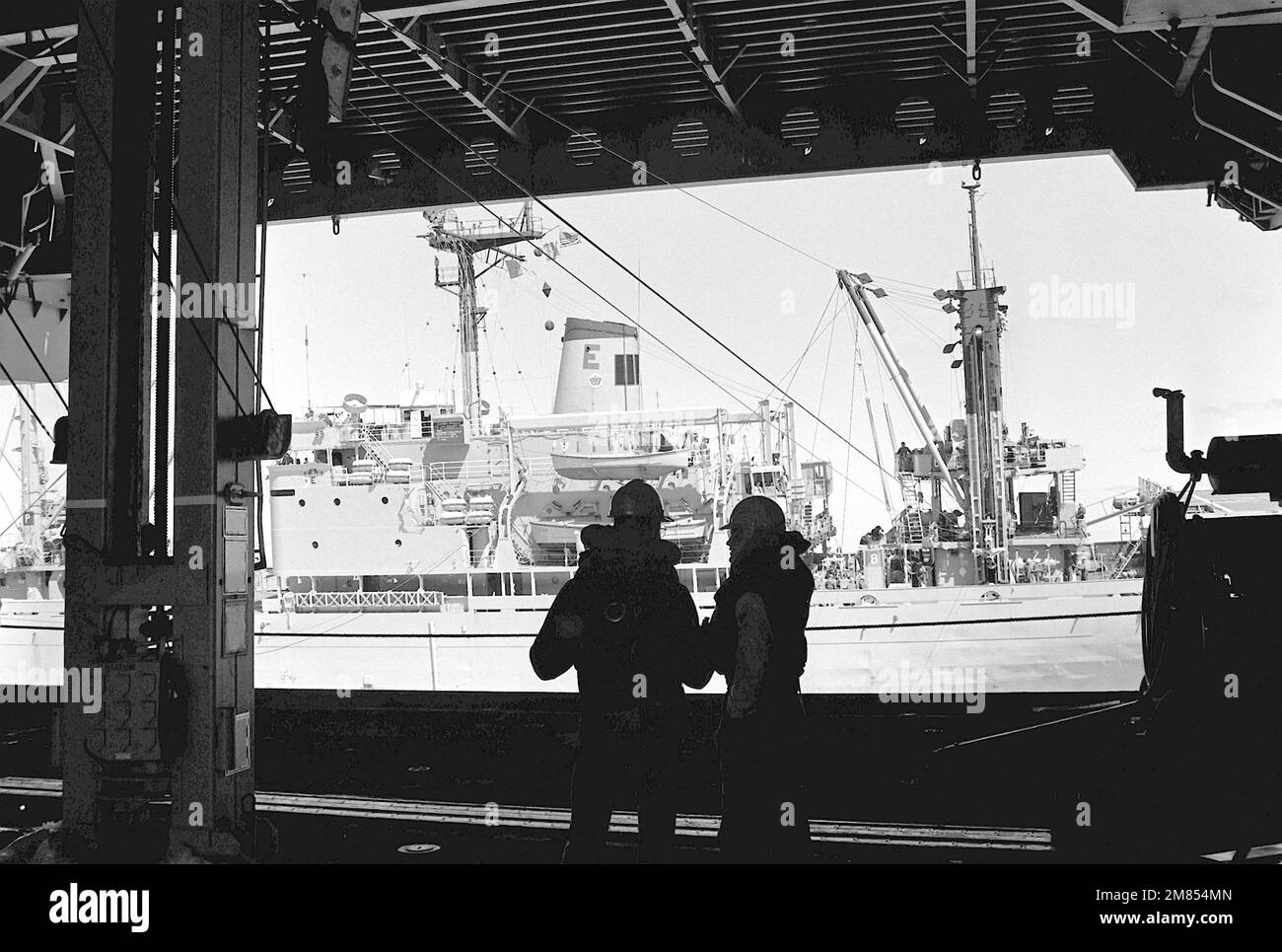 Crew members on the hangar deck of the aircraft carrier USS ...