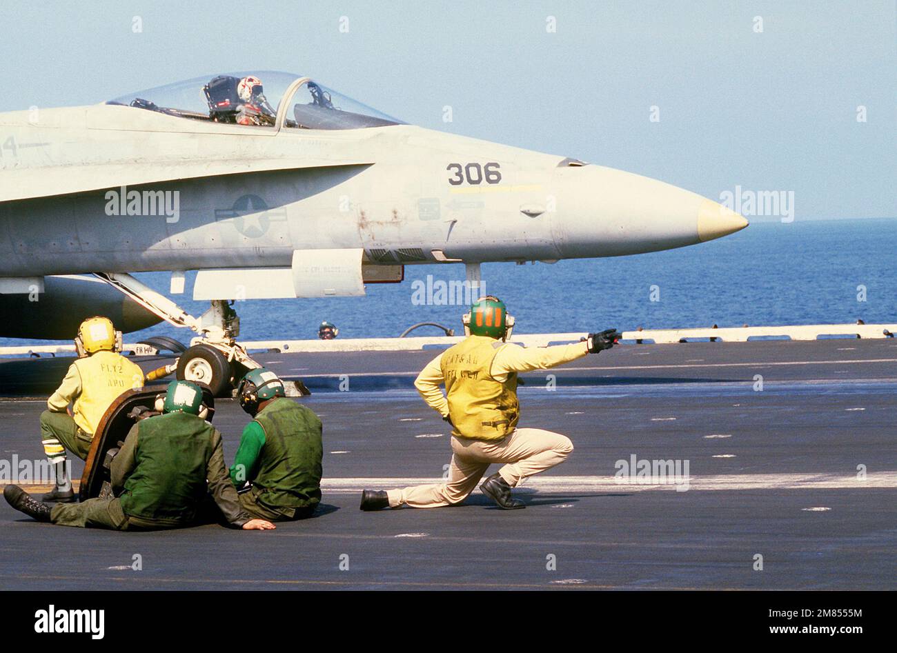 A catapult and arresting gear officer gives the launch signal to an F/A ...