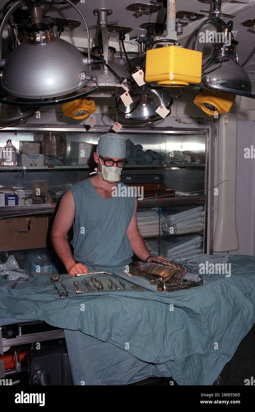A corpsman sets out sterilized operating equipment in an operating room ...