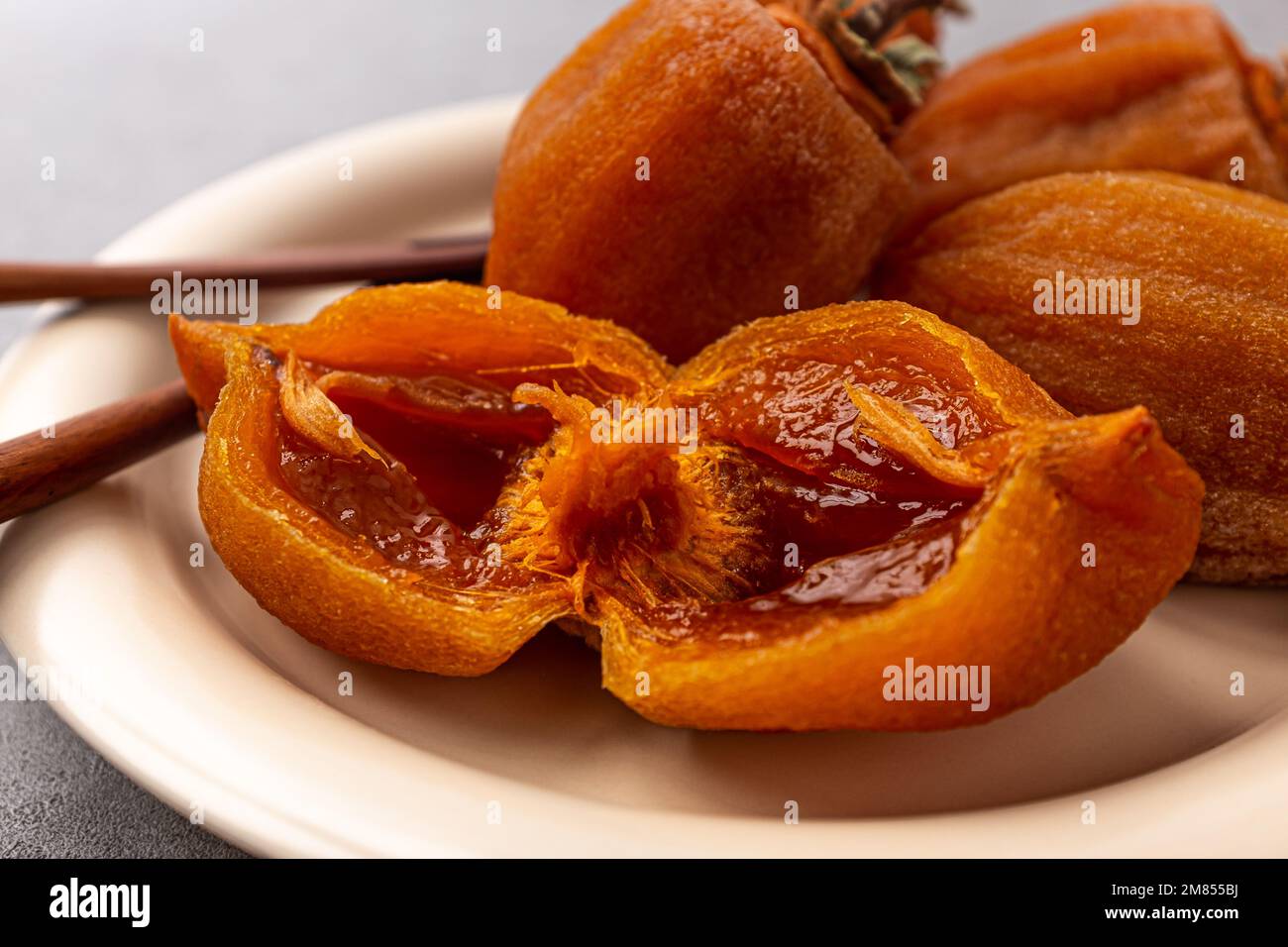Half-dried persimmon made by drying persimmons Stock Photo - Alamy