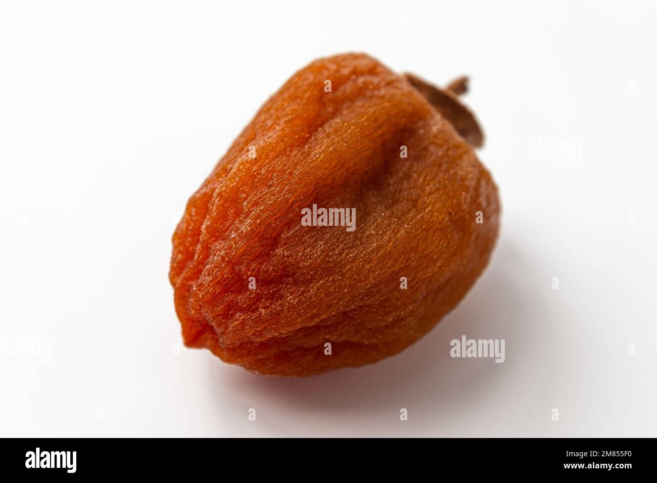 Half dried persimmon on a white background Stock Photo - Alamy