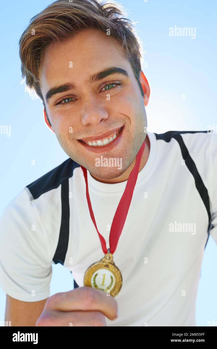 I always aim for the gold. Smiling medal winner holding his award ...