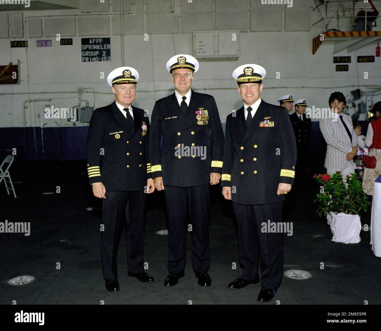 Posing for a photo during the change of command ceremony aboard the ...