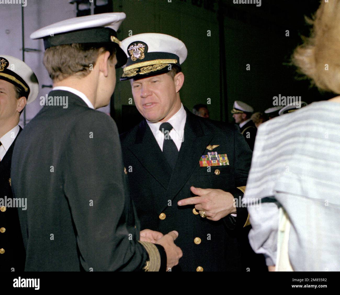 Guests shake hands with Rear Adm. (lower half) Thomas A. Mercer during ...