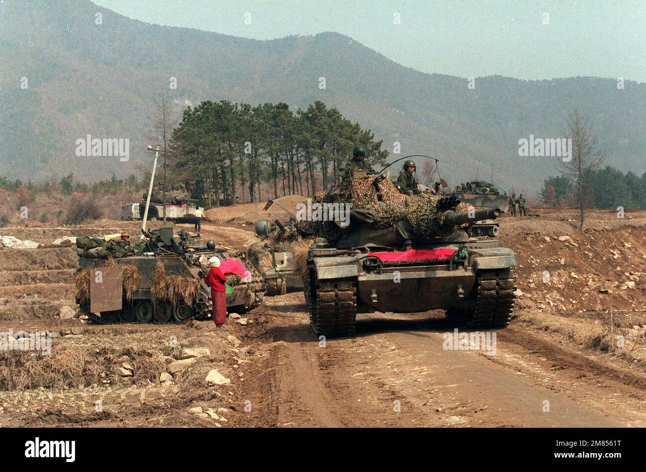 Armored vehicles of the 2nd Bn., 72nd Armor, 2nd Inf. Div., wait for ...