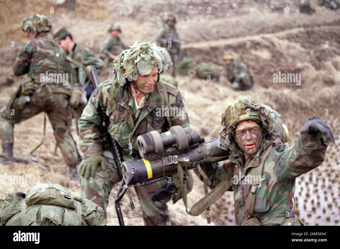 Members of the 1ST Bn., 38th Inf., 2nd Inf. Div., prepare to move an M ...
