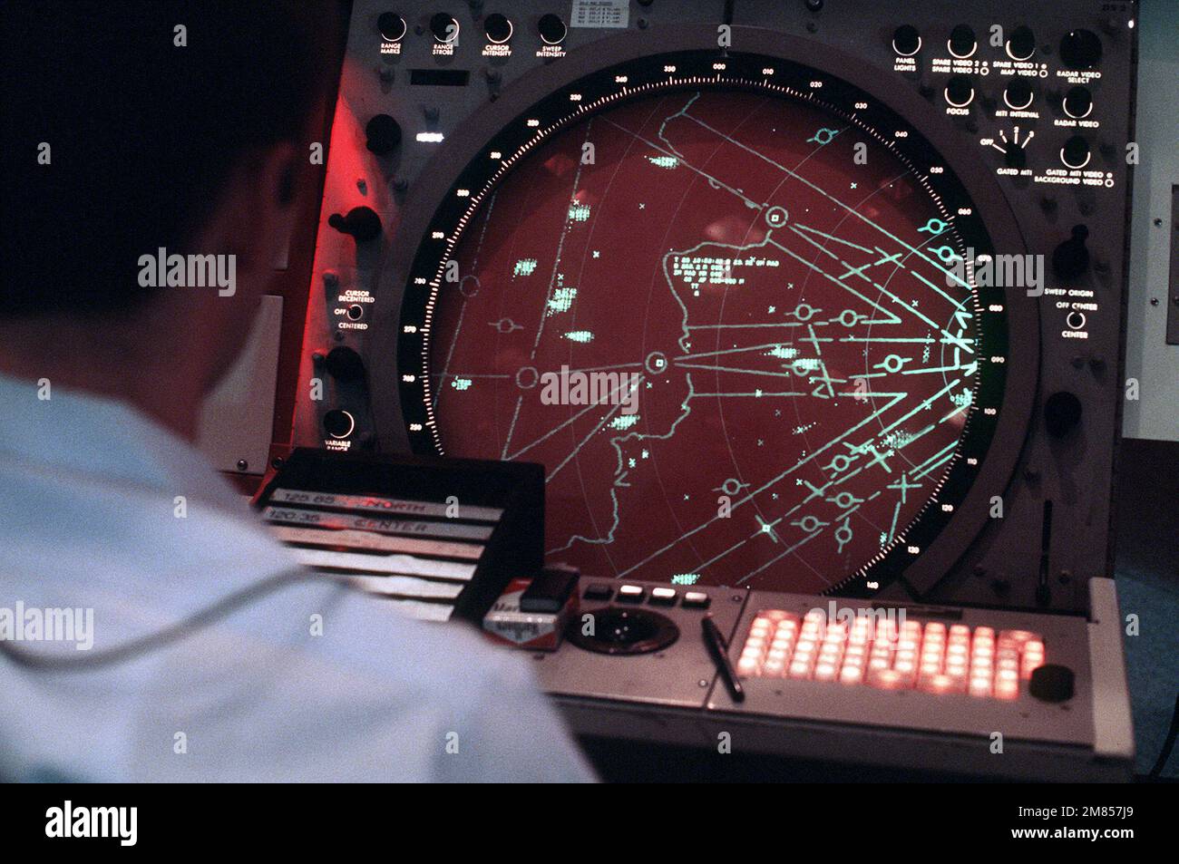 An airman monitors the new display console for the AN/FPS-117 air ...