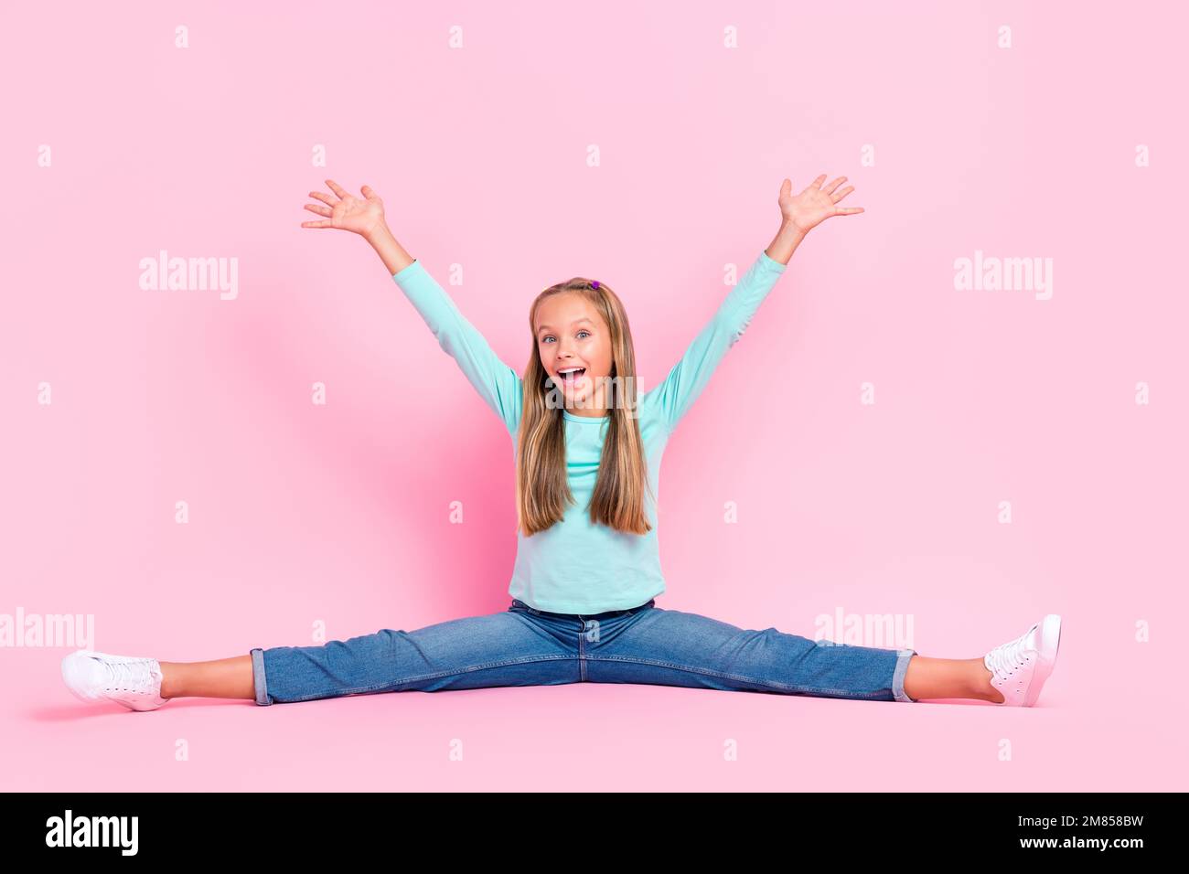 Full size portrait of astonished positive girl sit floor split legs ...