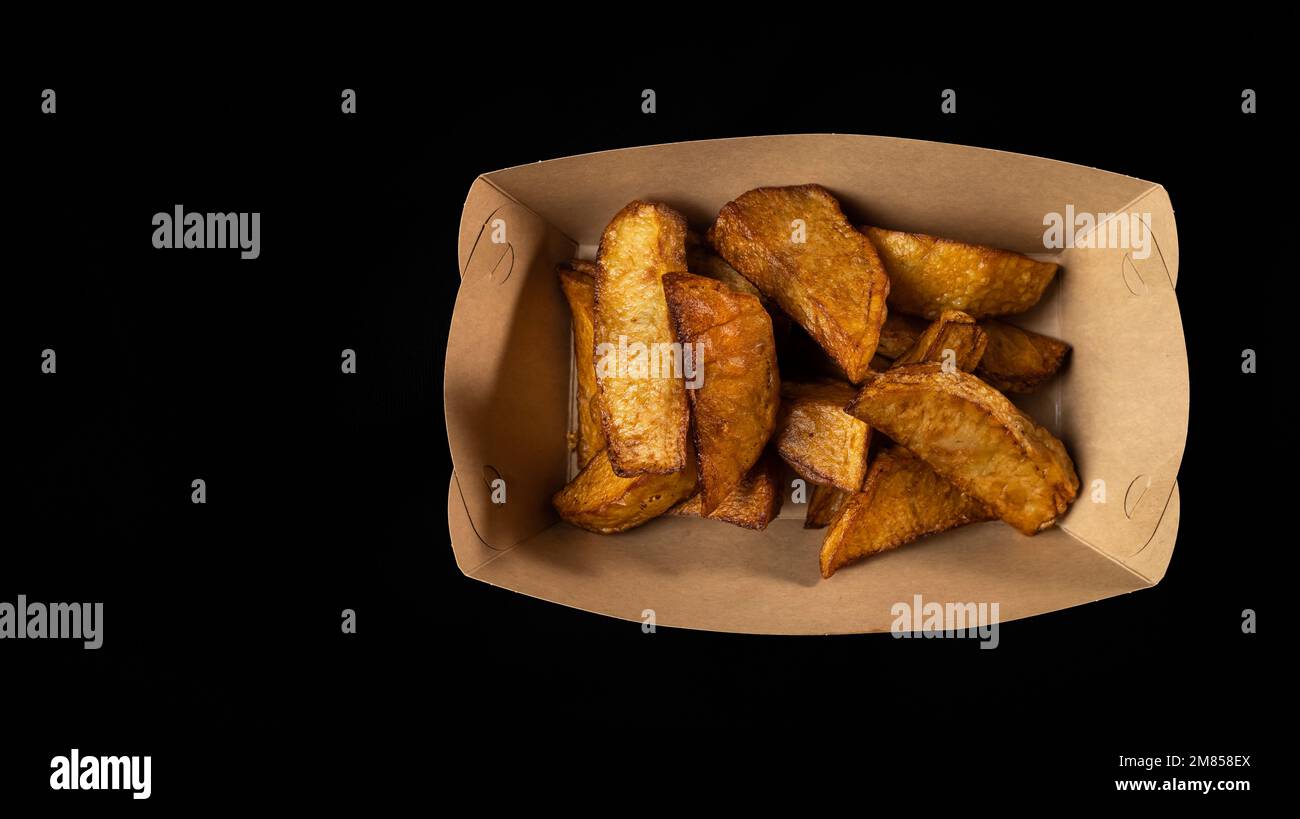 Baked potato slices in paper box Stock Photo - Alamy