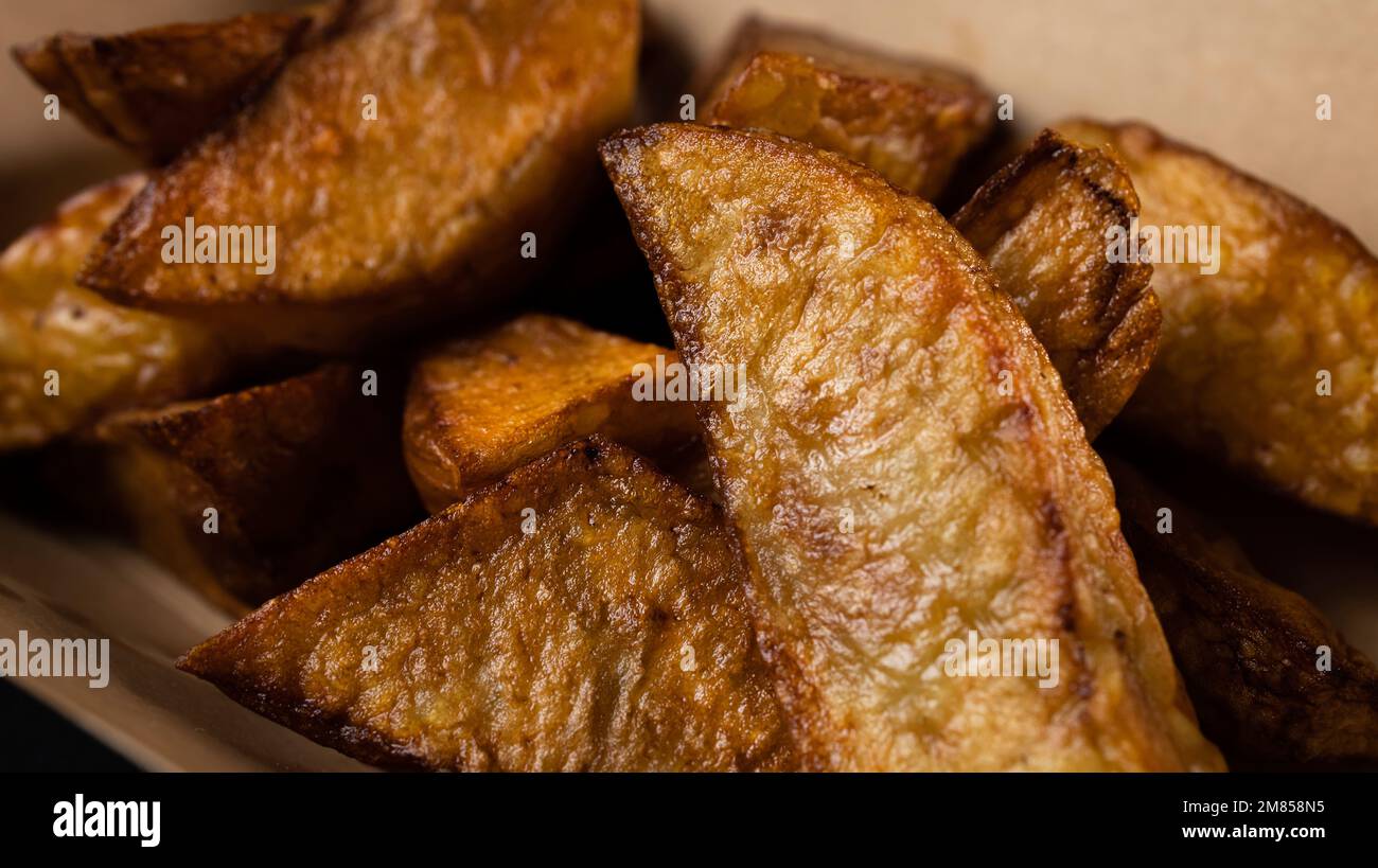 Baked potato slices in paper box Stock Photo - Alamy