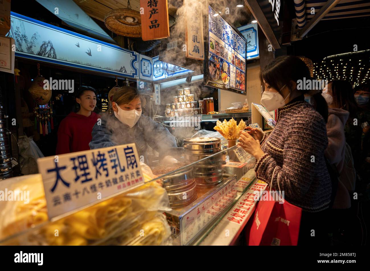 Kunming, China's Yunnan Province. 11th Jan, 2023. Residents buy snacks ...
