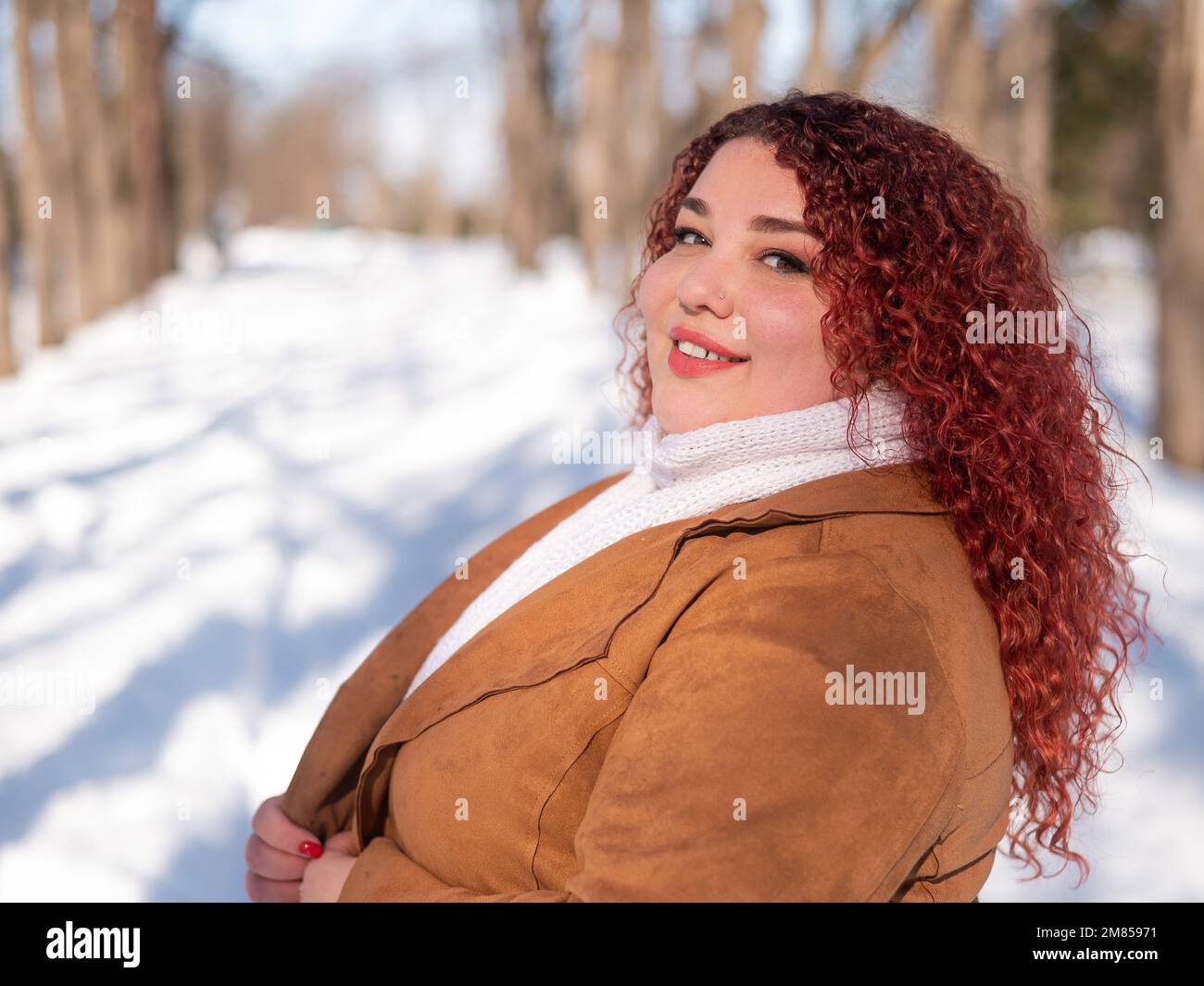 Cheerful fat caucasian woman walks in the park in winter Stock Photo ...