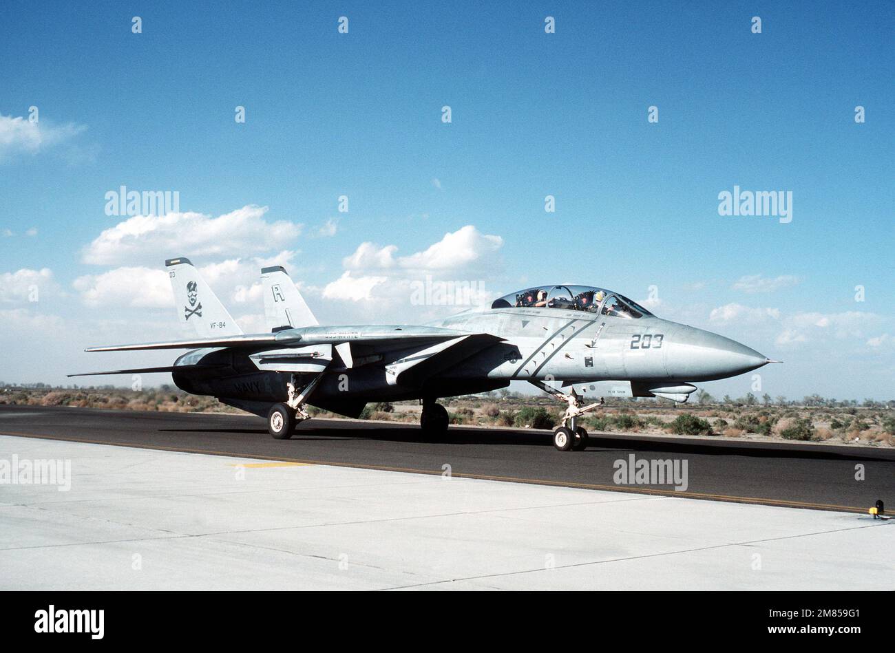 A Fighter Squadron 84 (VF-84) F-14A Tomcat aircraft taxis on the runway ...