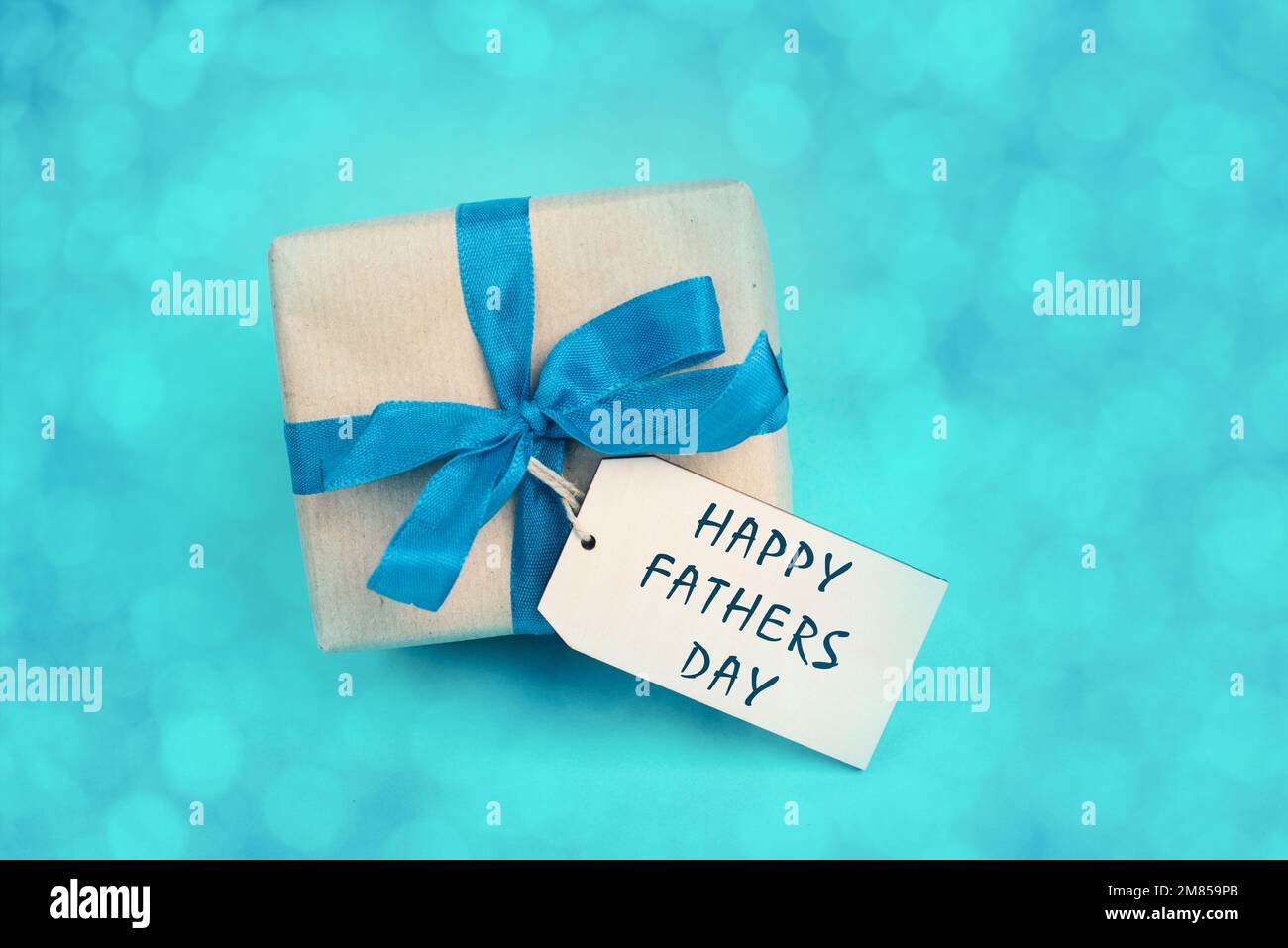 Gift box with ribbon and bow for fathers day, blue bokeh light ...