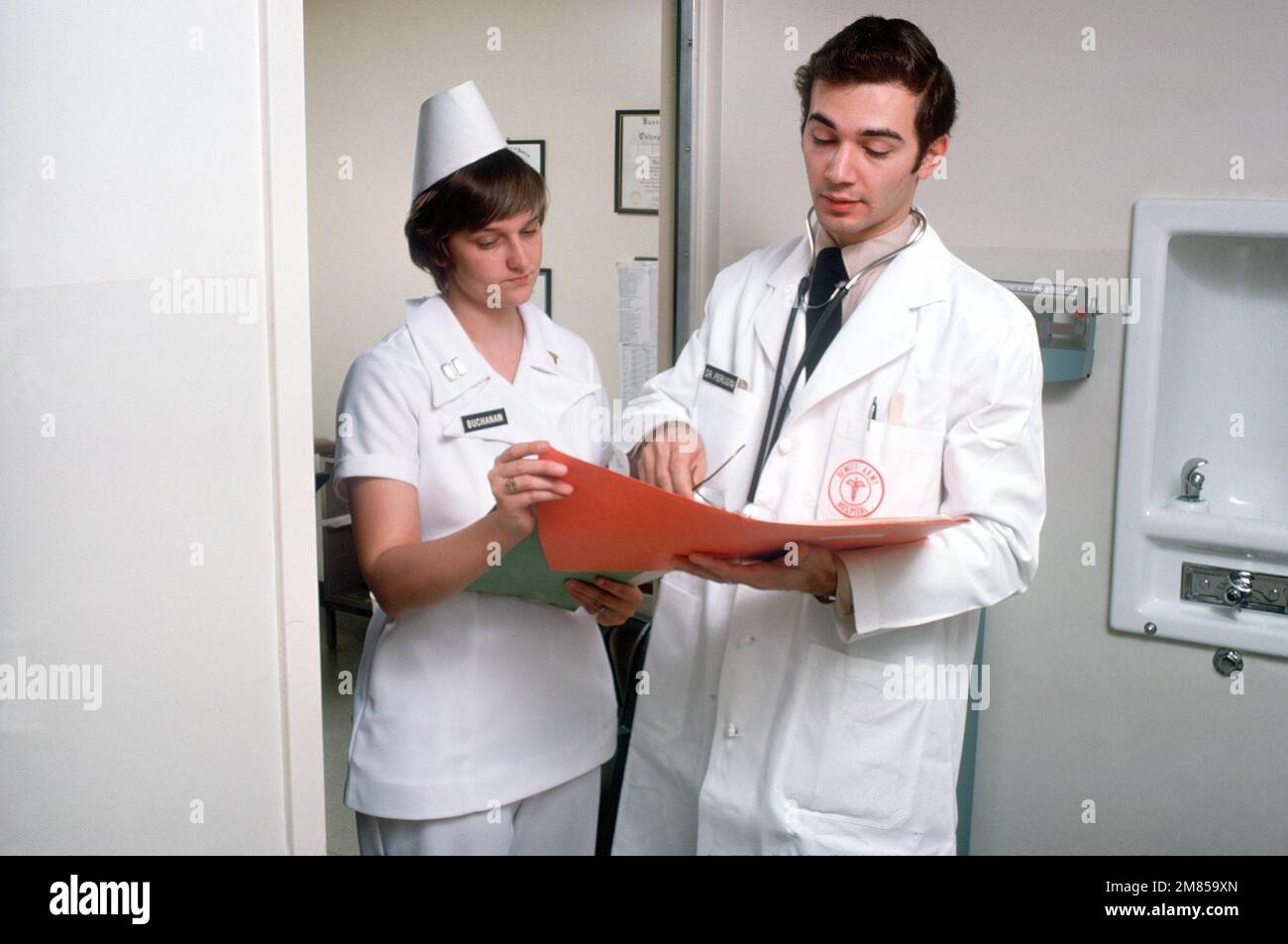 A U.S. Army doctor reviews charts with a nurse at Dewitt Army Hospital ...