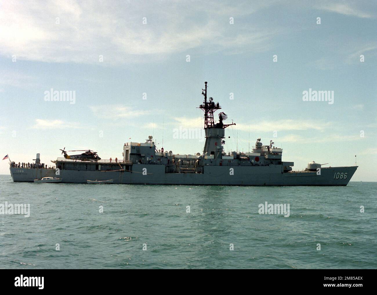 A starboard beam view of the frigate USS BREWTON (FF-1086) anchored off ...