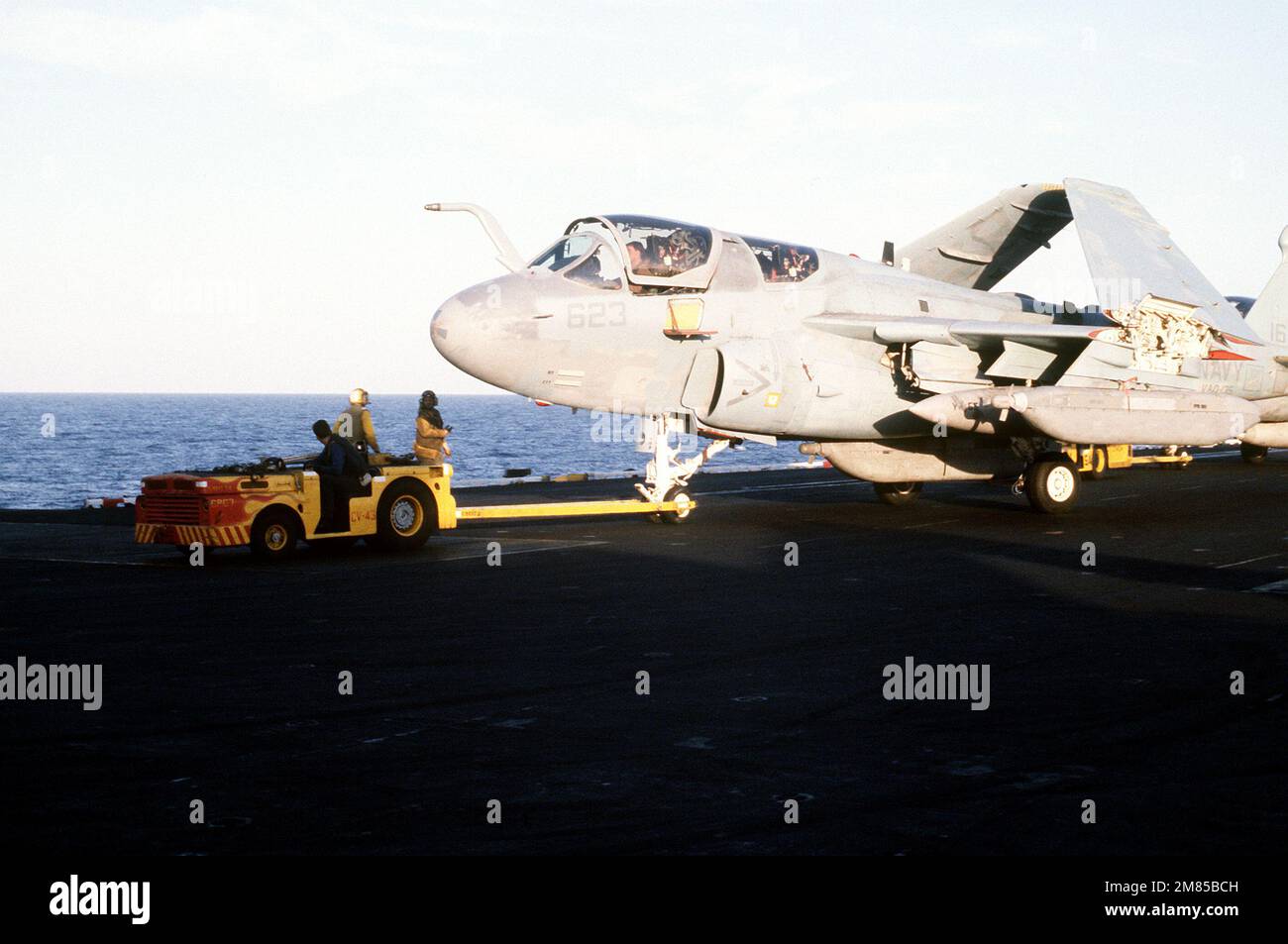 An MD-3A tow tractor is used to position an EA-6B Prowler aircraft from ...