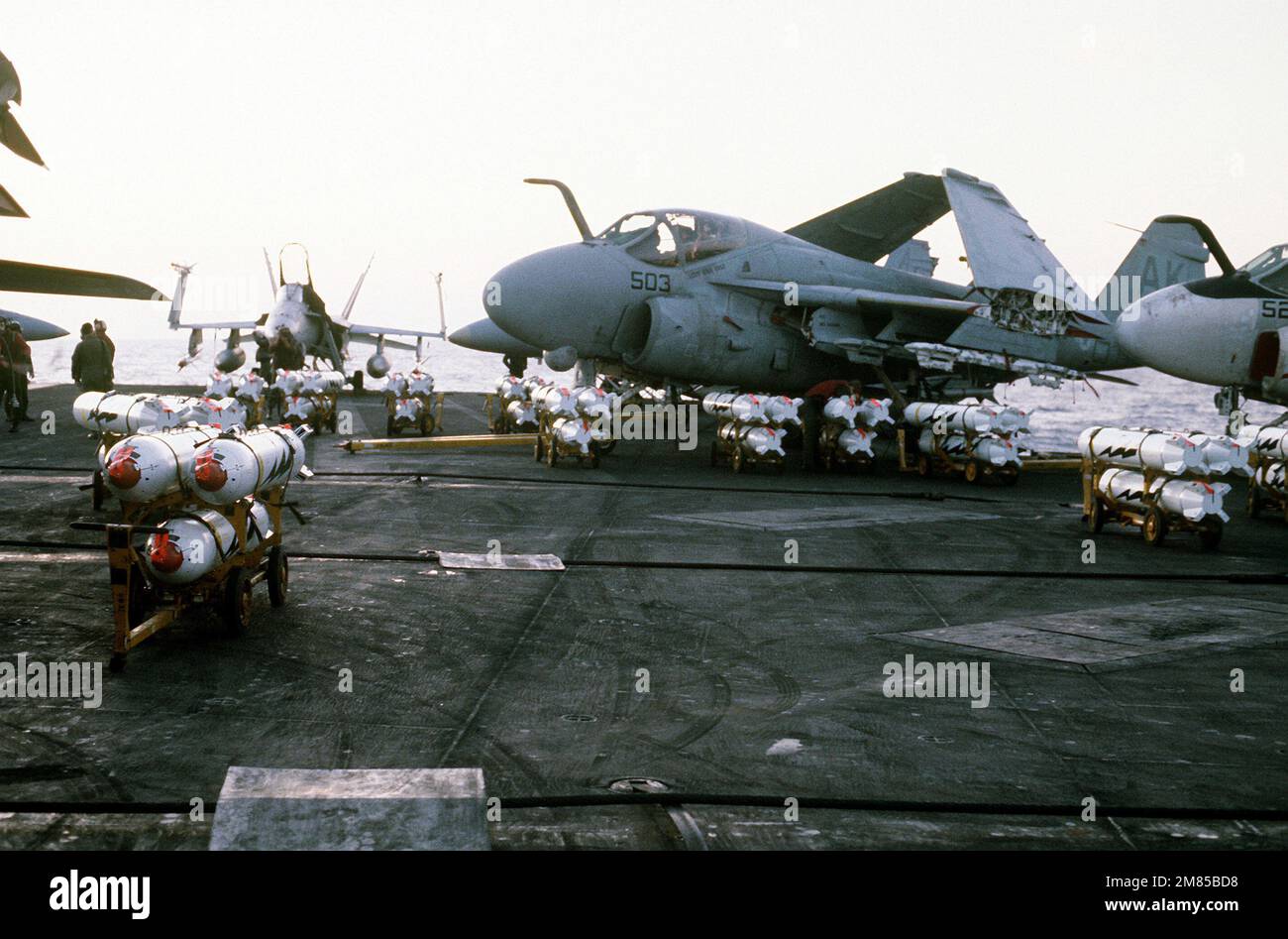 Bomb skids loaded with CBU-59 cluster bombs are staged on the flight ...