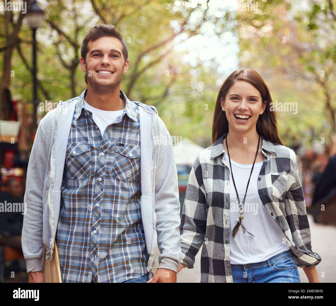 They enjoy the same things. A young couple walking hand in hand Stock ...