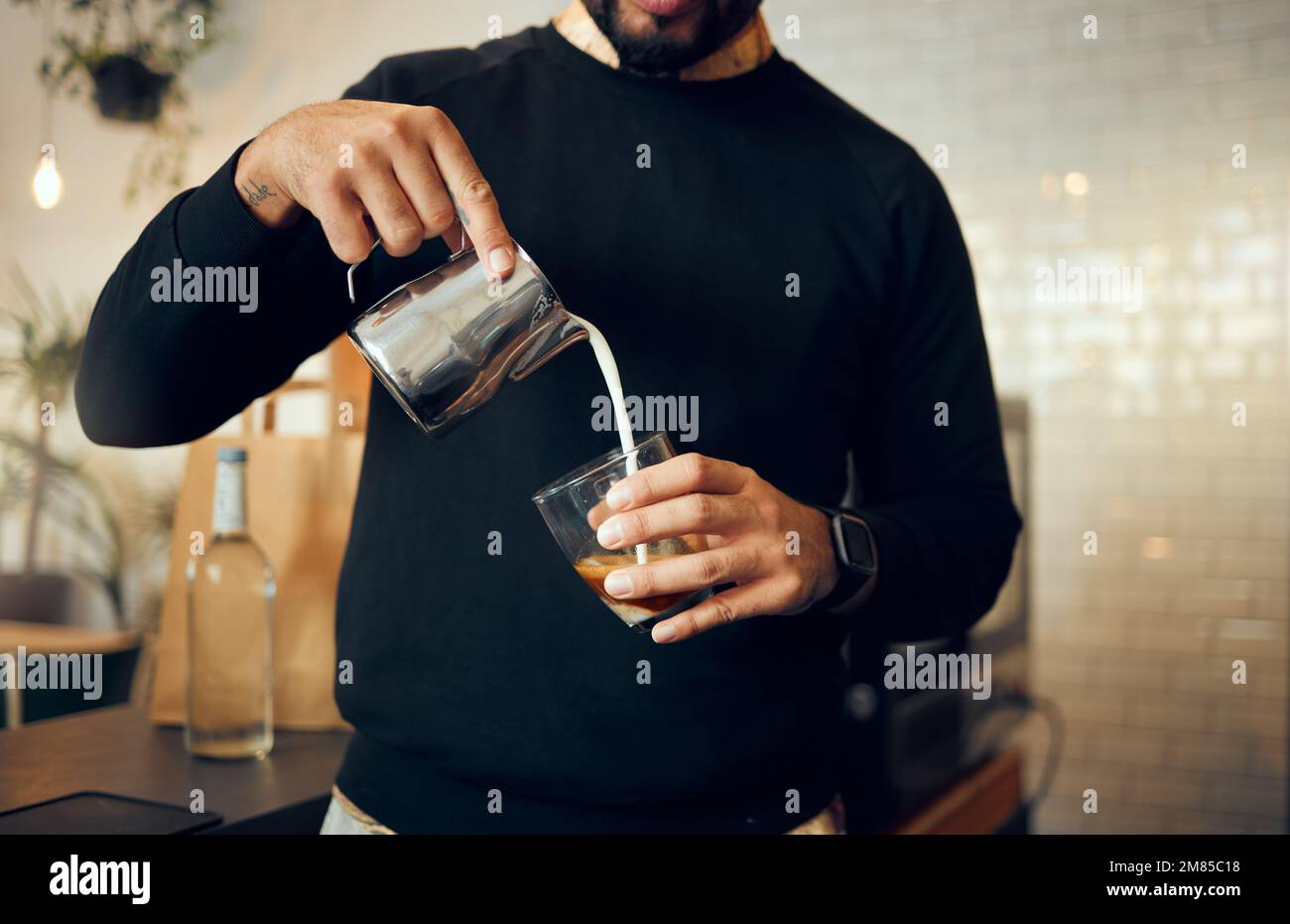 Coffee, milk and hands of man in cafe for cappuccino, breakfast and ...