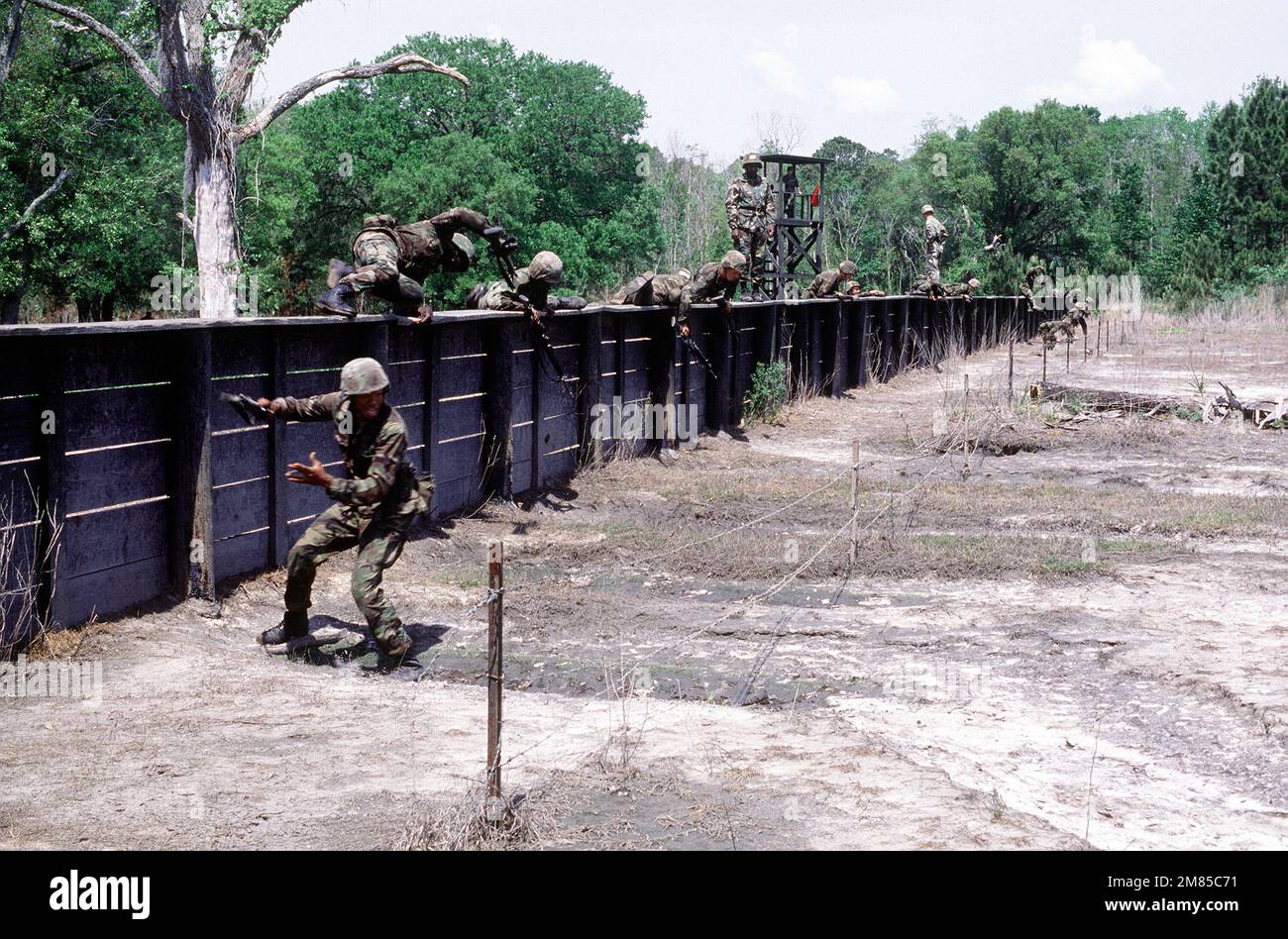 Marine recruits scale a wall on an obstacle course at the Marine Corps ...