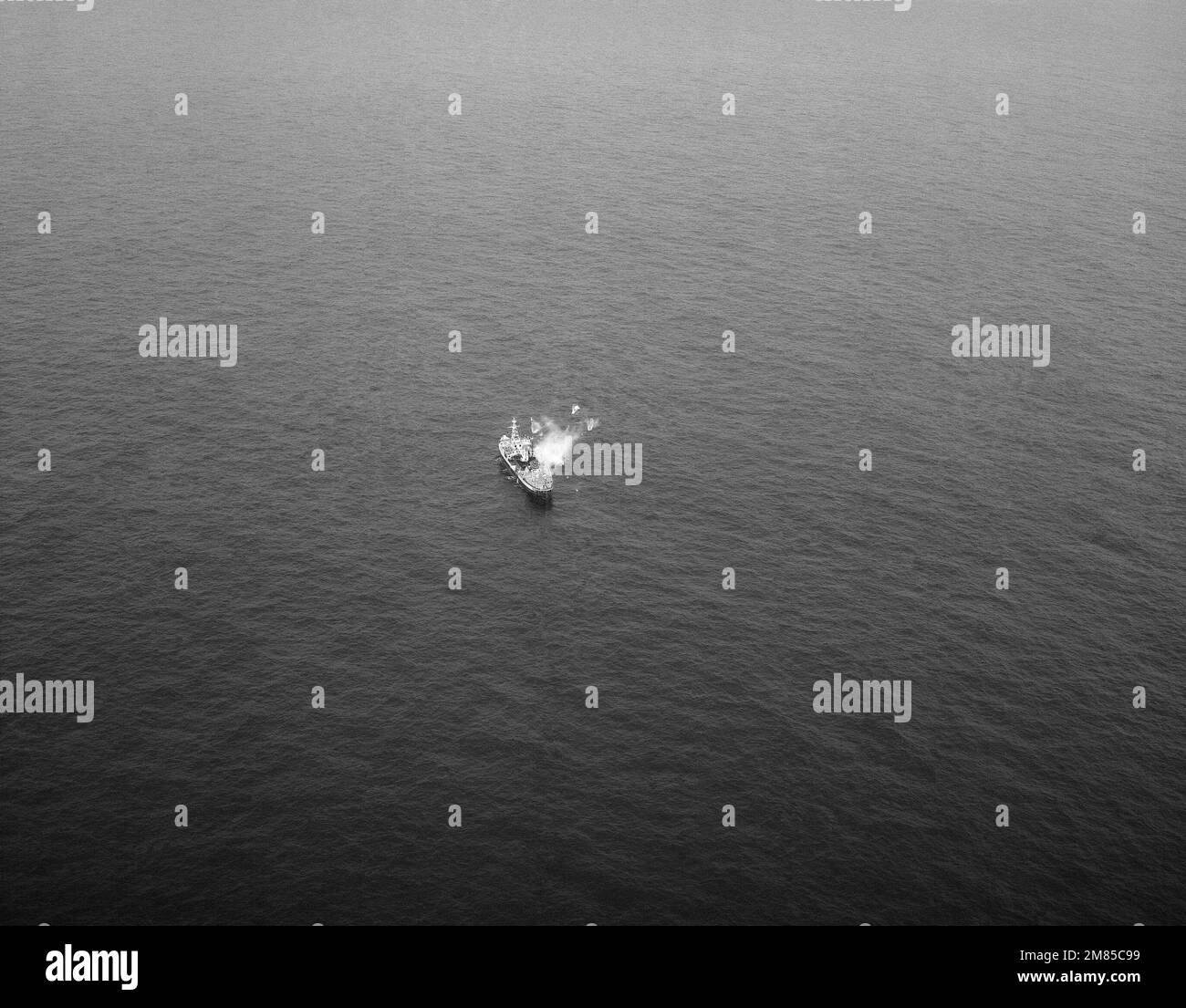 The ex-Army hopper dredge Davison, serving as a target hulk, is hit by ...