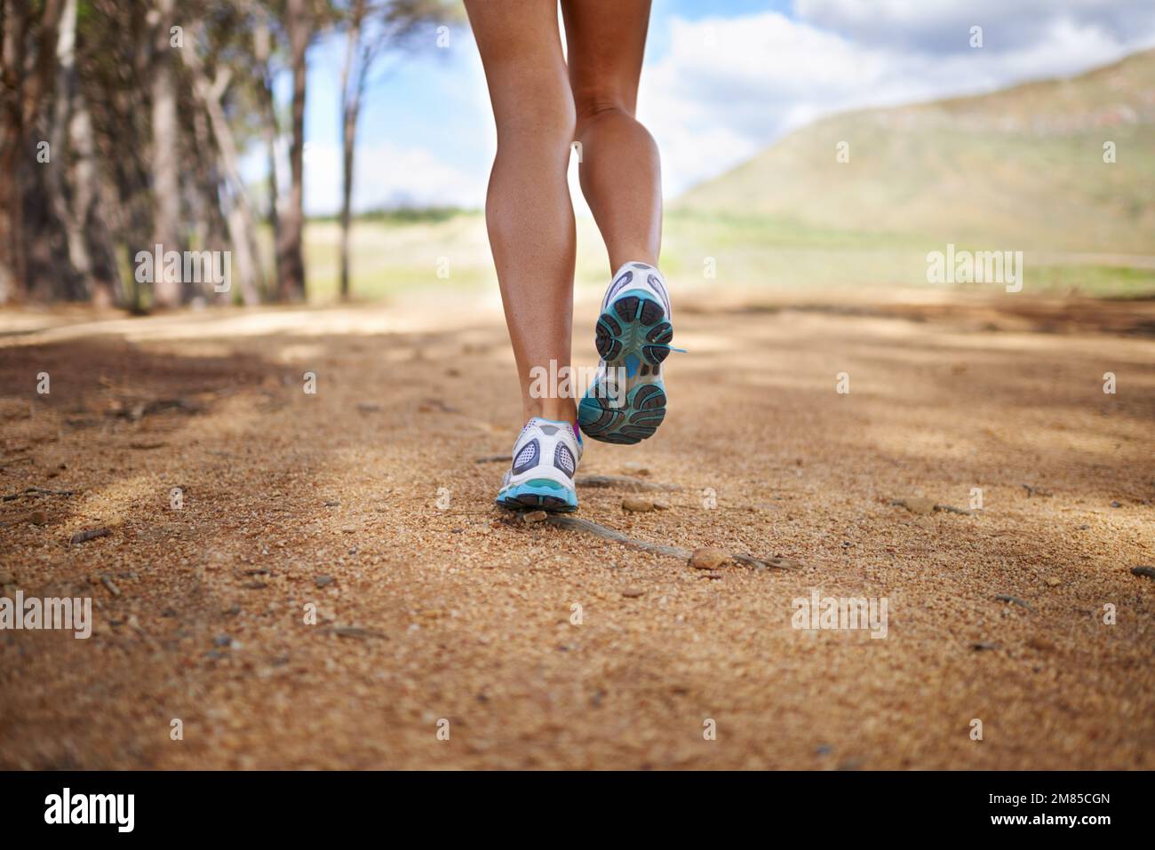 Going for a trail run. Cropped view of a womans legs running through a ...