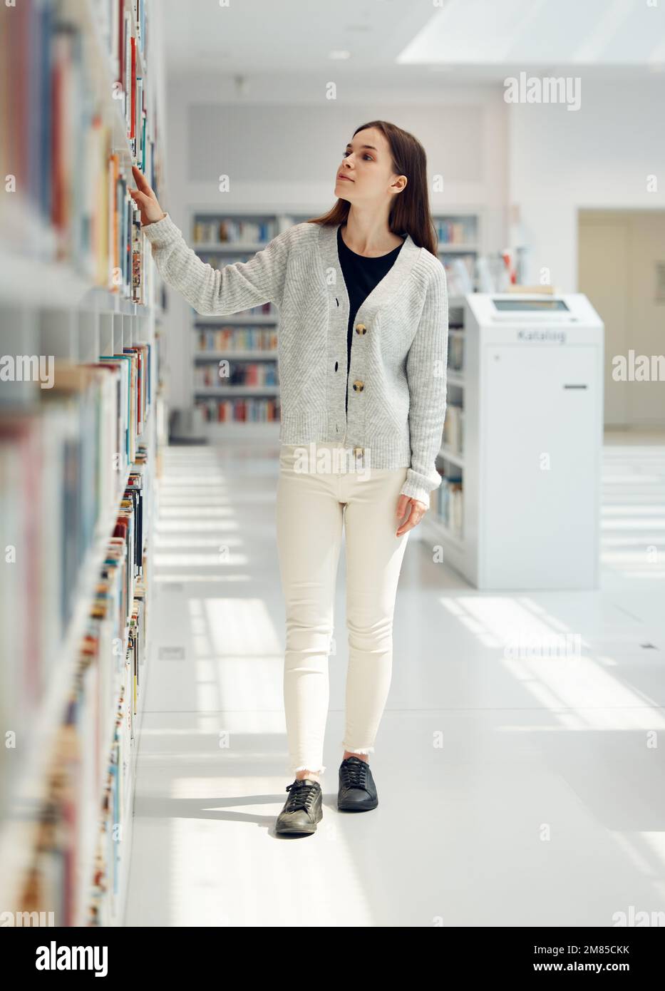 Woman, student and search in library for book choice, knowledge or ...